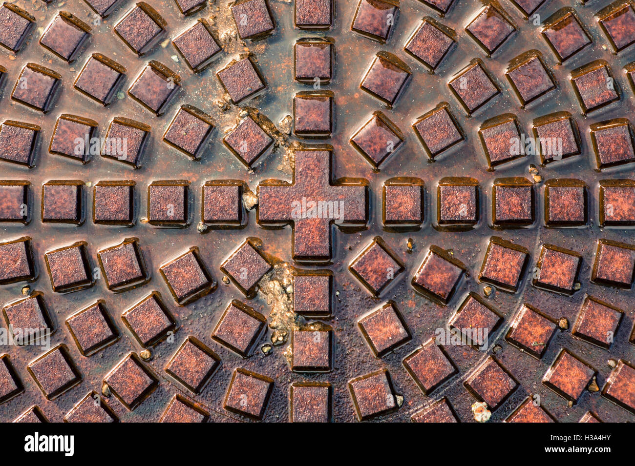 Rain Soaked Road or Roadside Manhole Cover In Close Up Stock Photo - Alamy