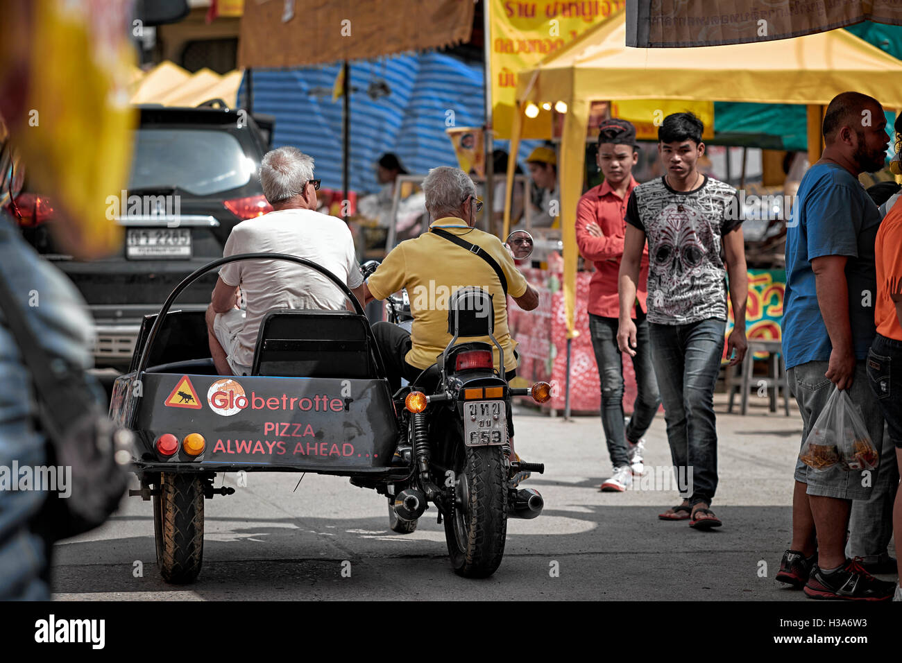 Motorcycle sidecar. Senior Caucasian males riding a motorcycle and ...