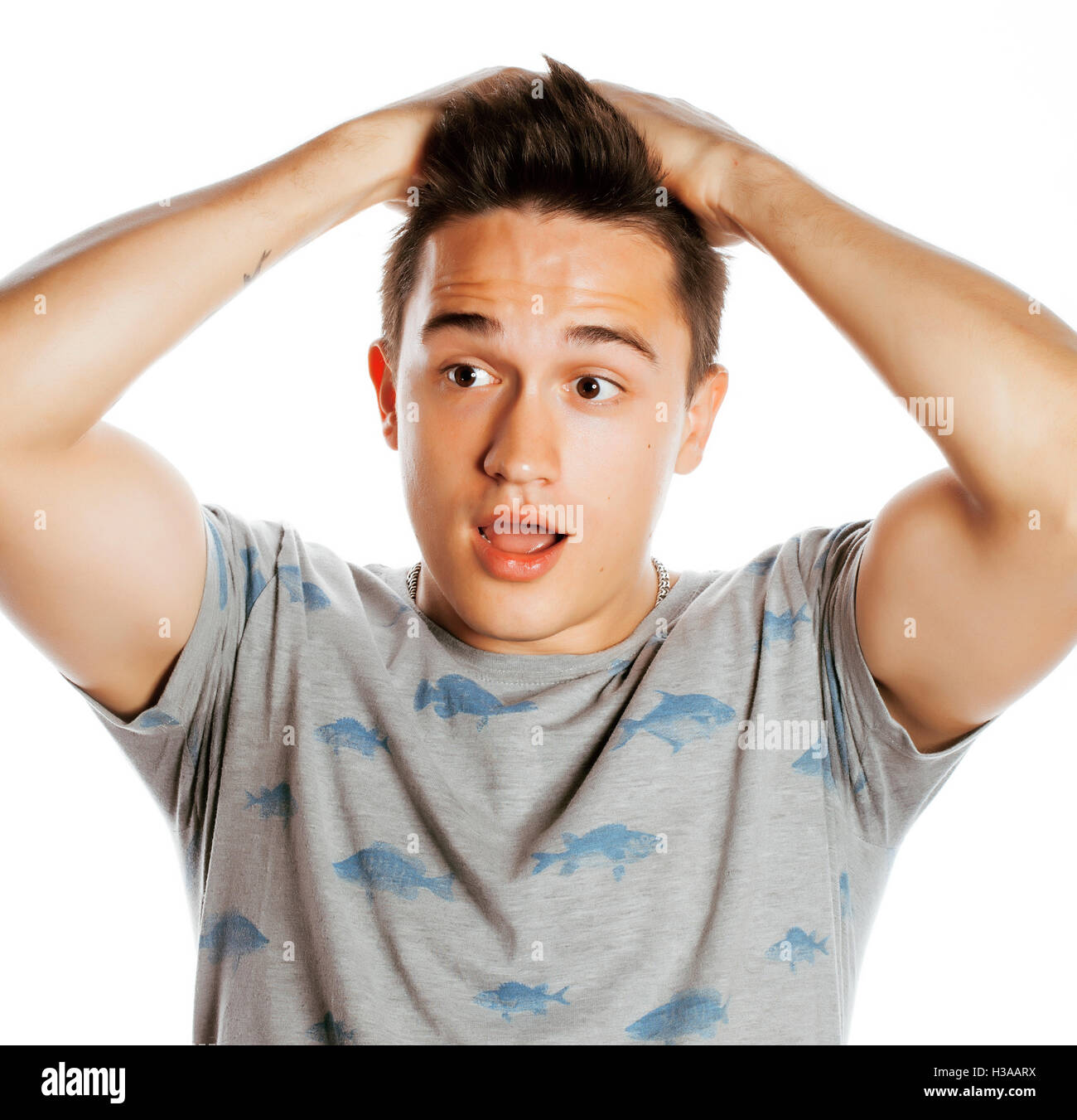 Young attractive handsome man holding hands on his head emotional ...