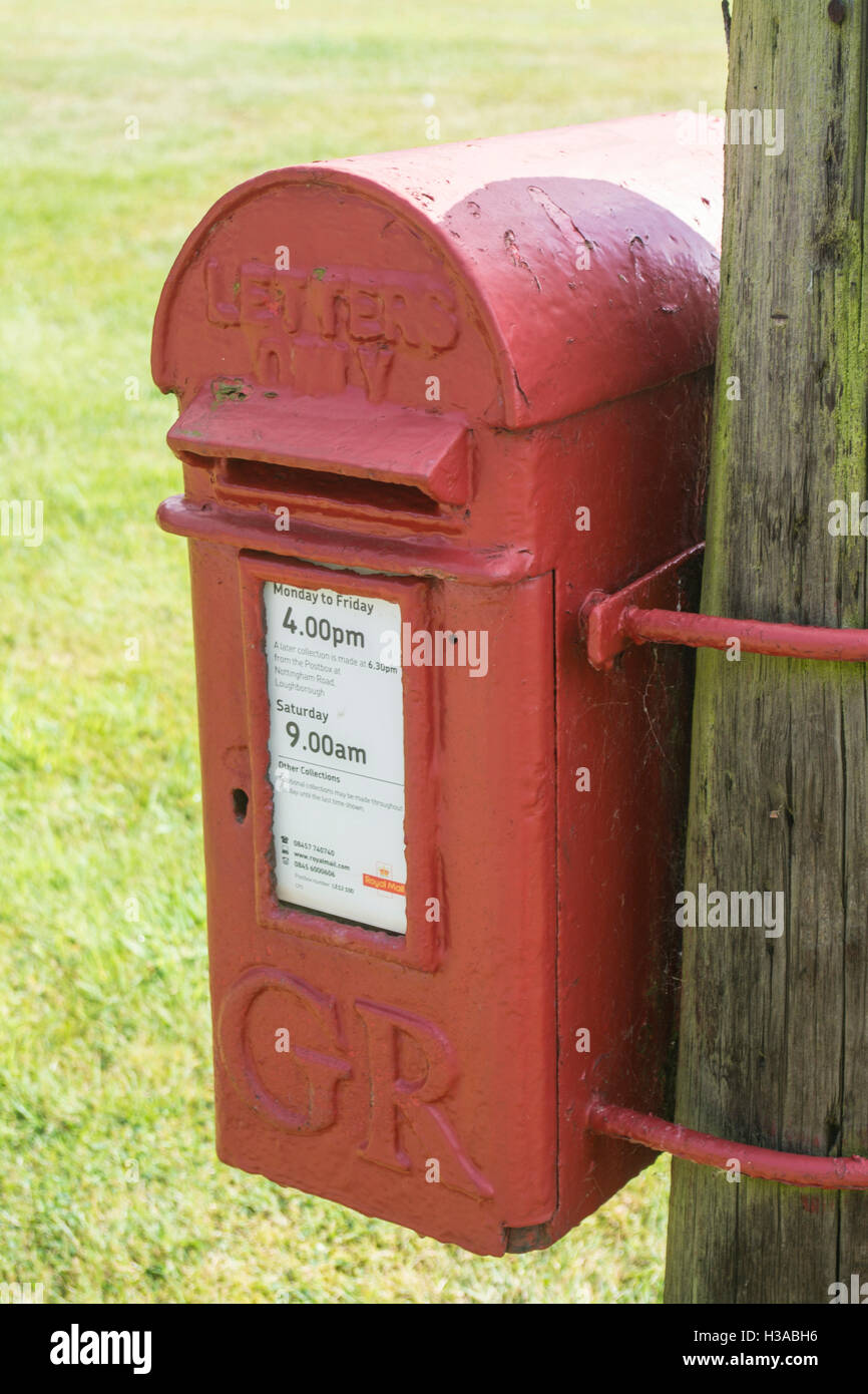 Royal Mail small red Post box mounted on a tree in the small village of ...