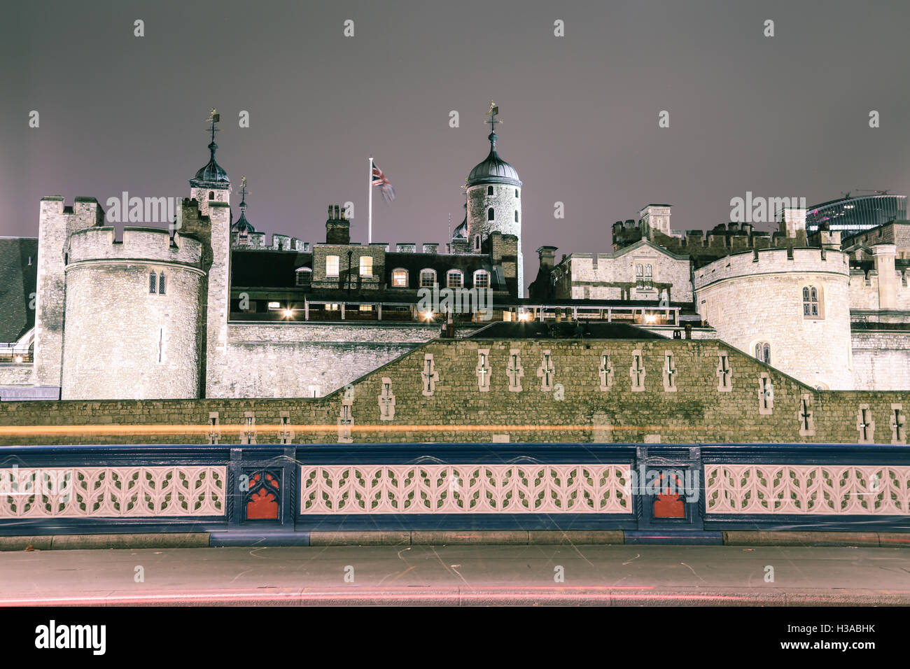 The Tower of London viewed from the side at night, against the hazy ...