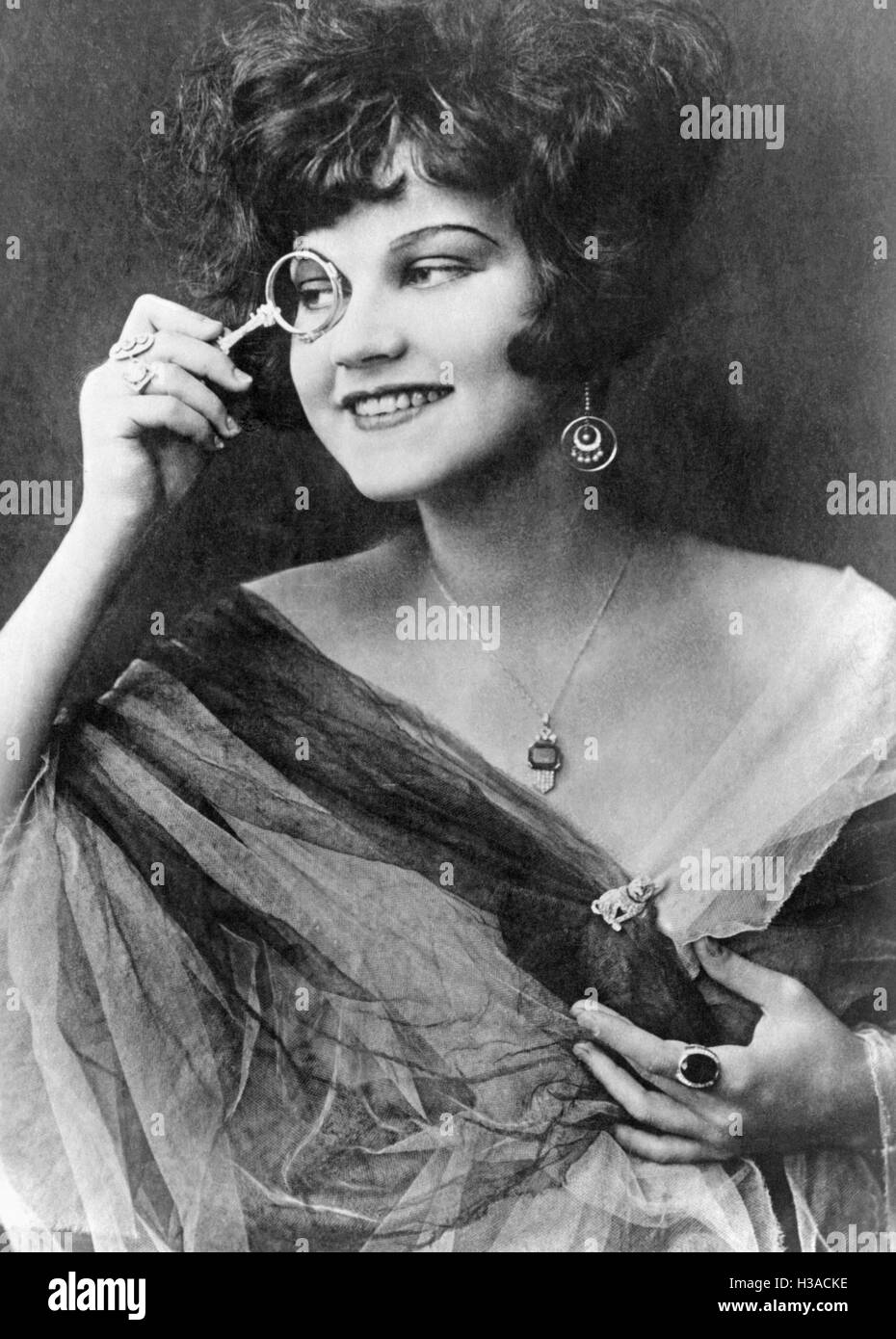 Young woman with lorgnette, 20s Stock Photo - Alamy