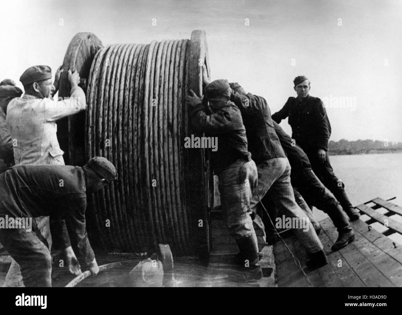 German troops lay telephone cable through the Dnieper, 1941 Stock Photo ...