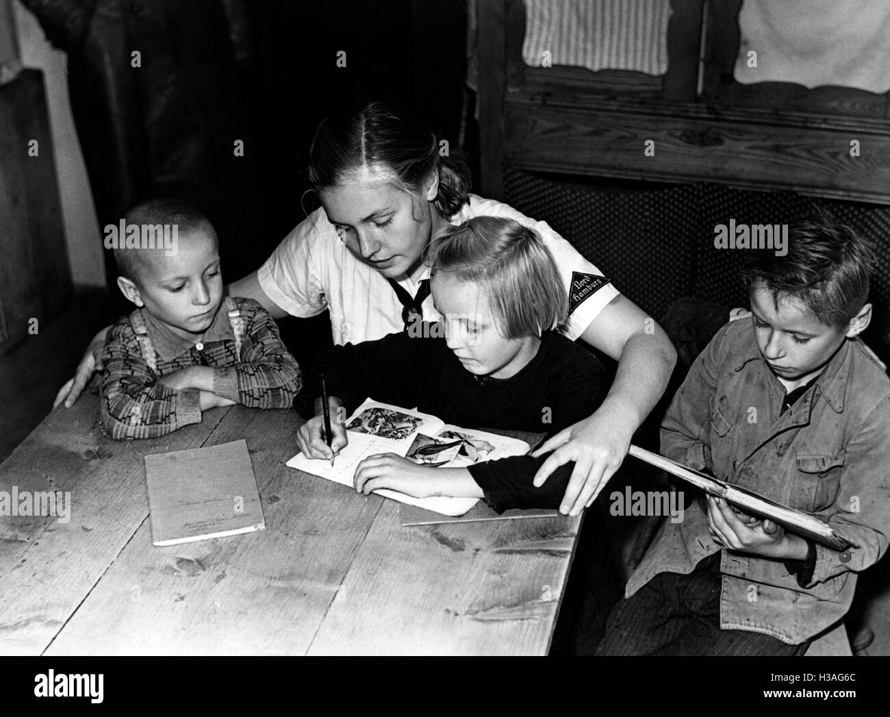 BDM leader as child care worker, 1940 Stock Photo - Alamy