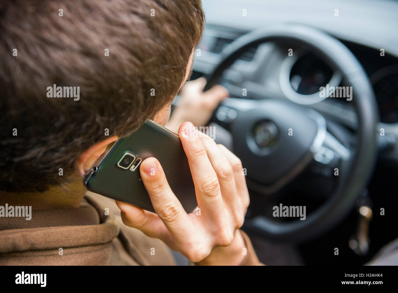 Man sitting in car using a mobile phone, UK Stock Photo - Alamy