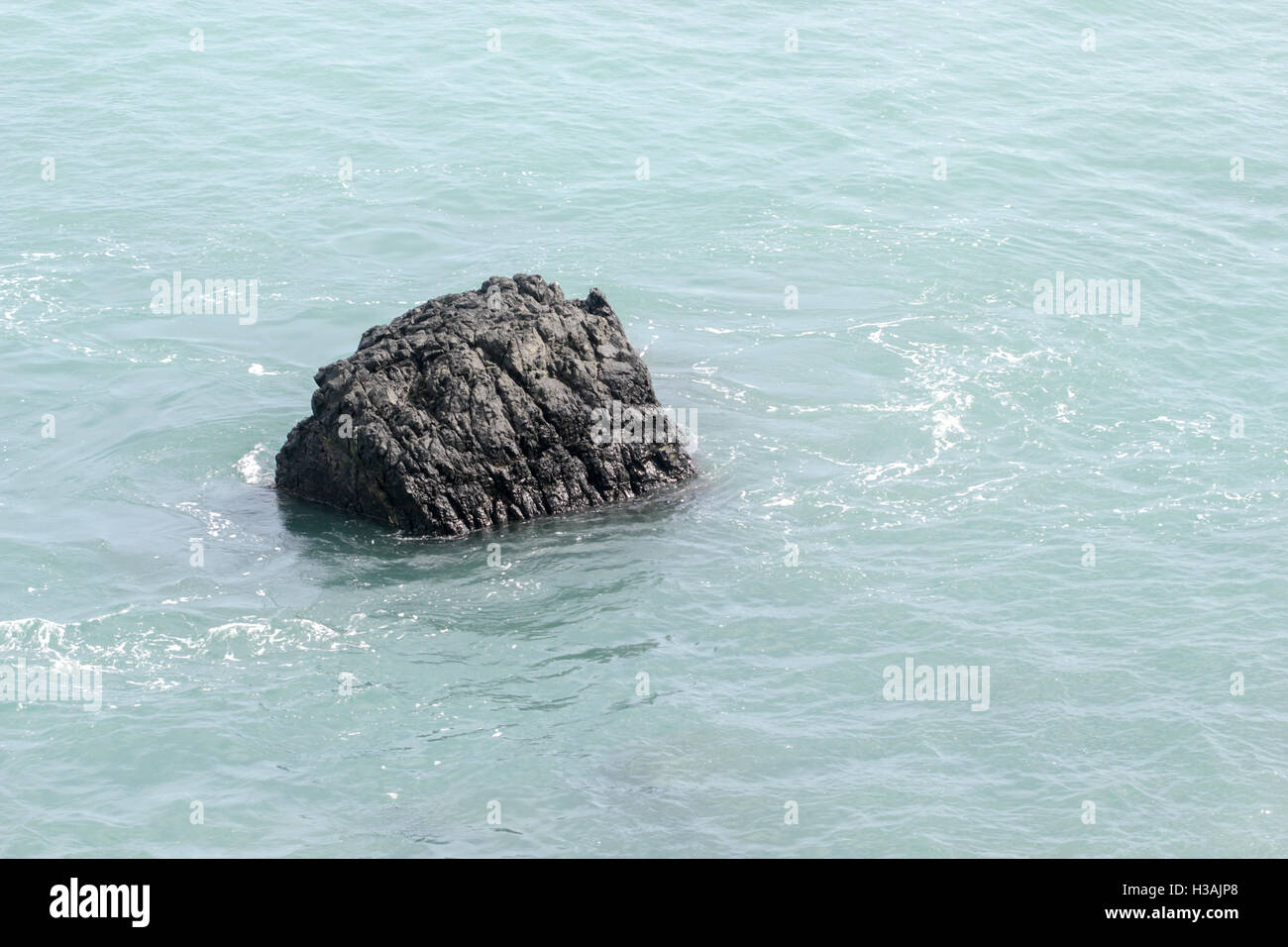 ROcks inside the blue ocean Stock Photo - Alamy