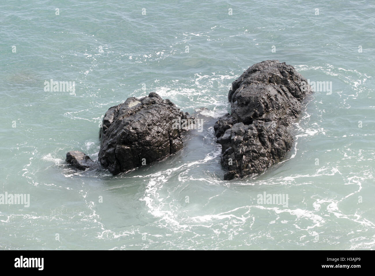 ROcks inside the blue ocean Stock Photo - Alamy