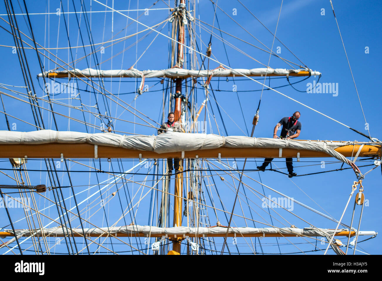 Beautiful tall wooden antique war ship at the harbor loading and ...