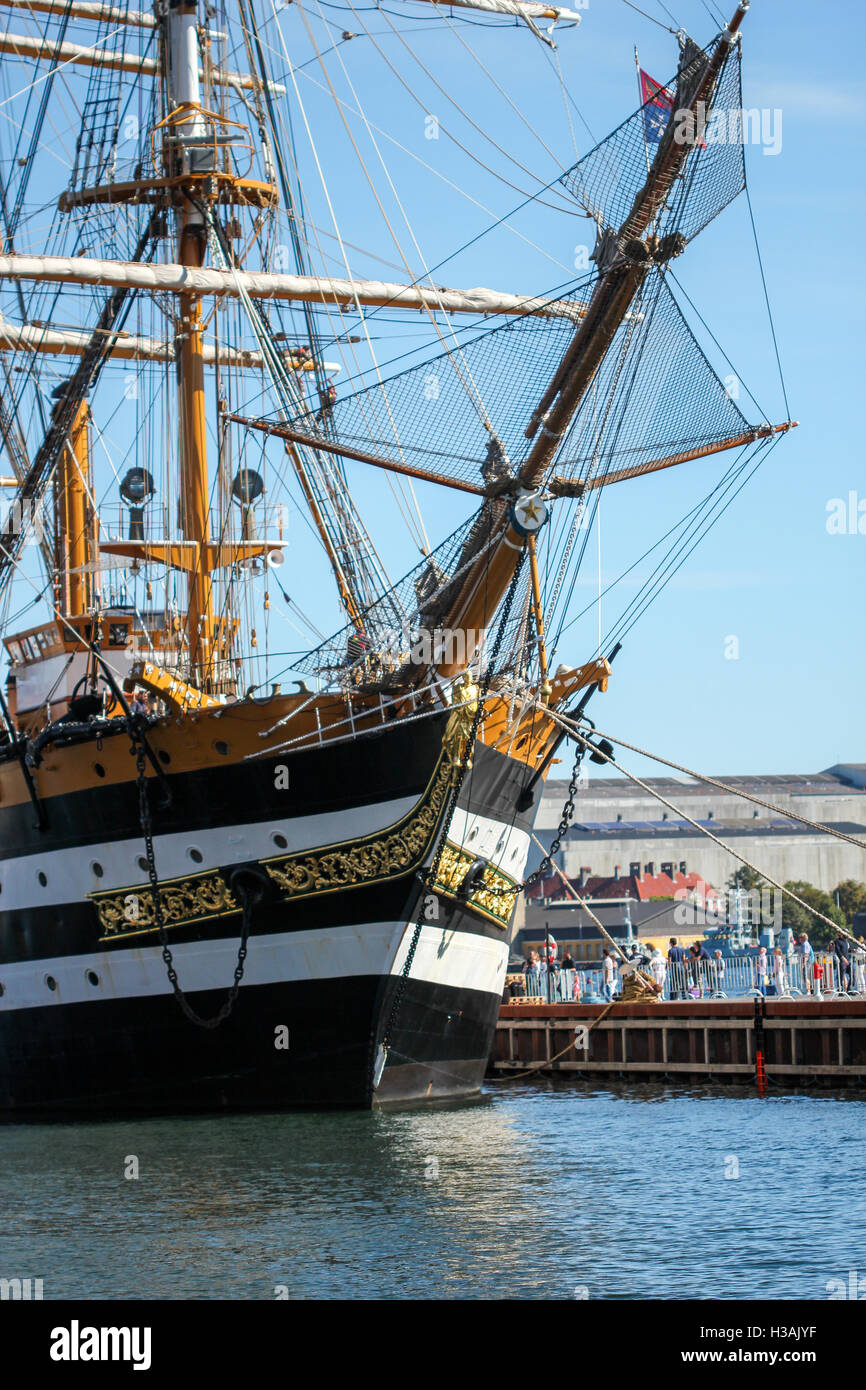 Beautiful tall wooden antique war ship at the harbor loading and ...