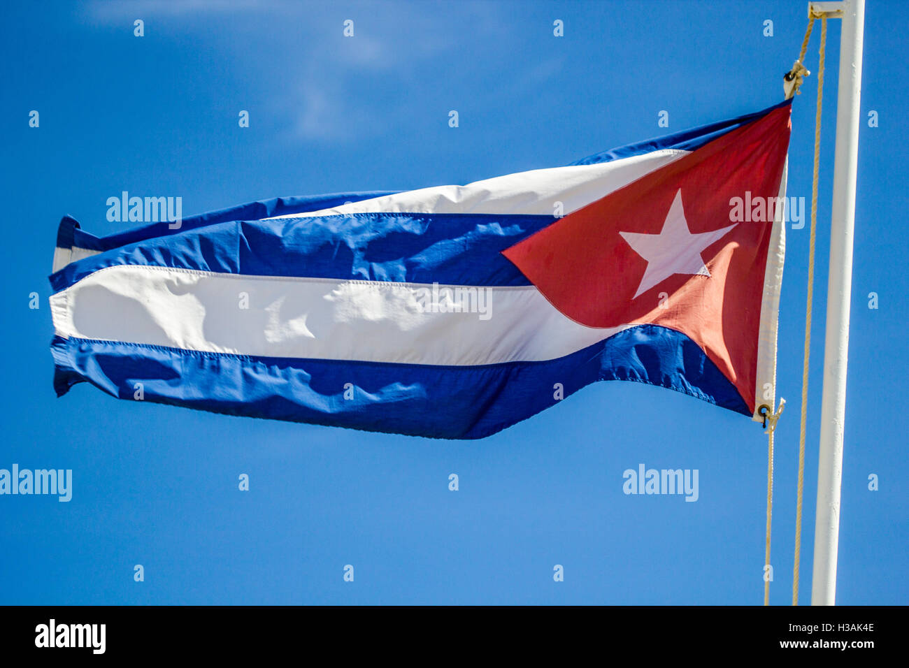 Flag of cuba in bright vibrant blue sky Stock Photo - Alamy