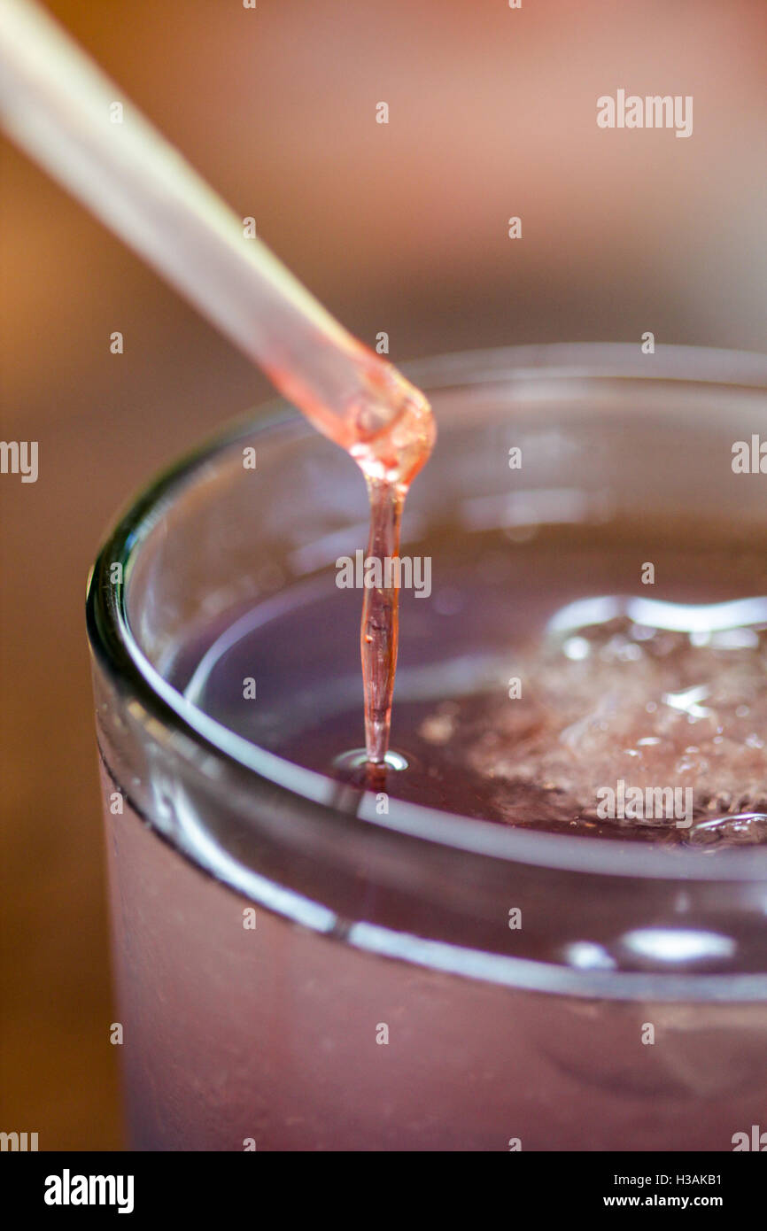 Alcoholic cocktail running through straw Stock Photo - Alamy