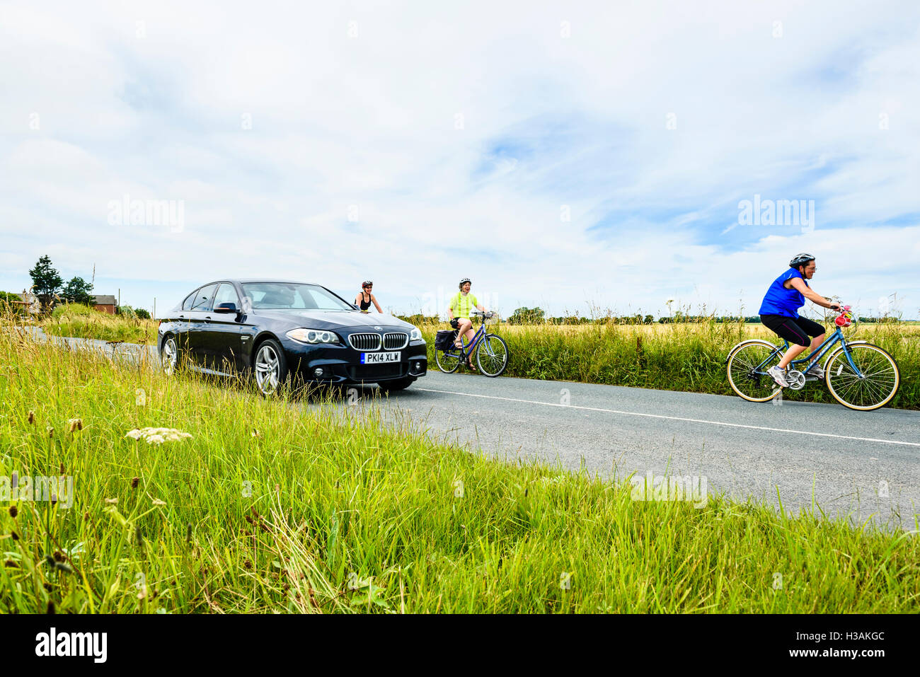 Car passing by woman hi-res stock photography and images - Alamy