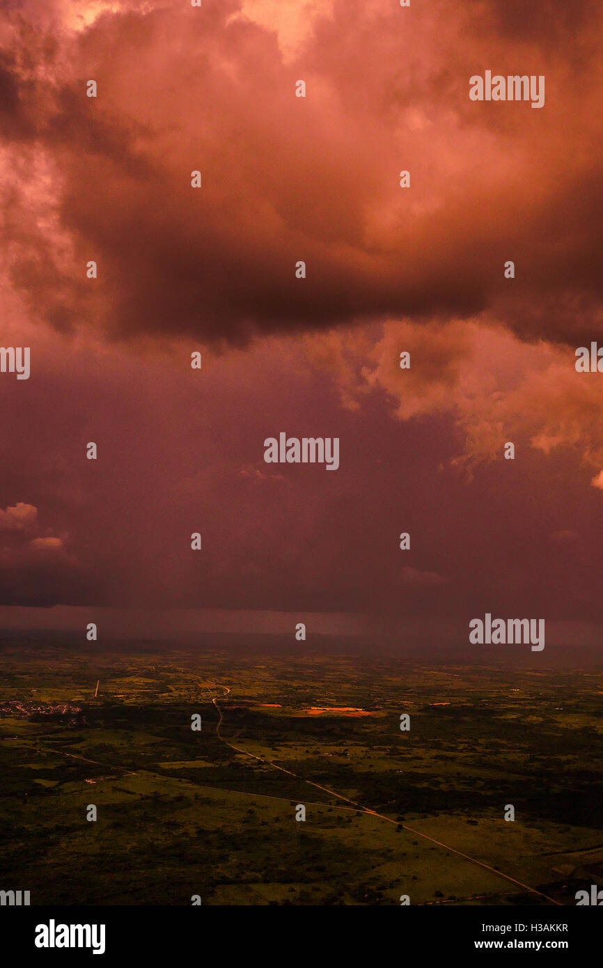 Red stormy and cloudy sky during the sunset through the window of a ...