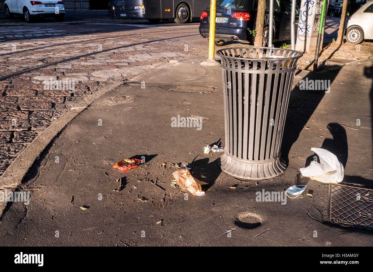 trash outside the trash bin in the city center after a loud and crazy ...