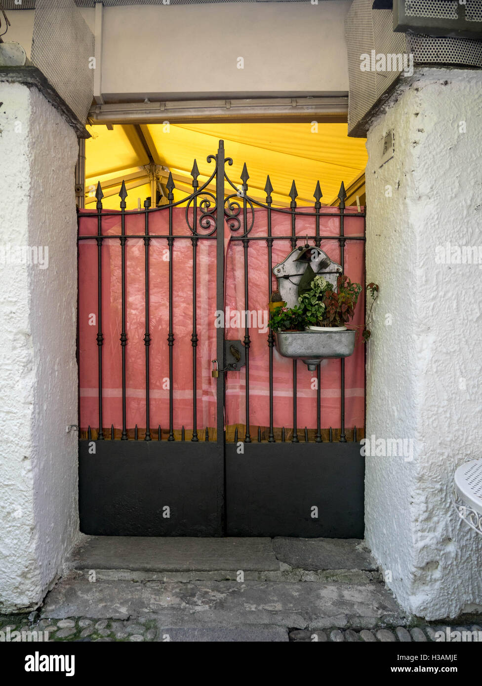 Closed gate to a private property in Italian style, bright colours ...