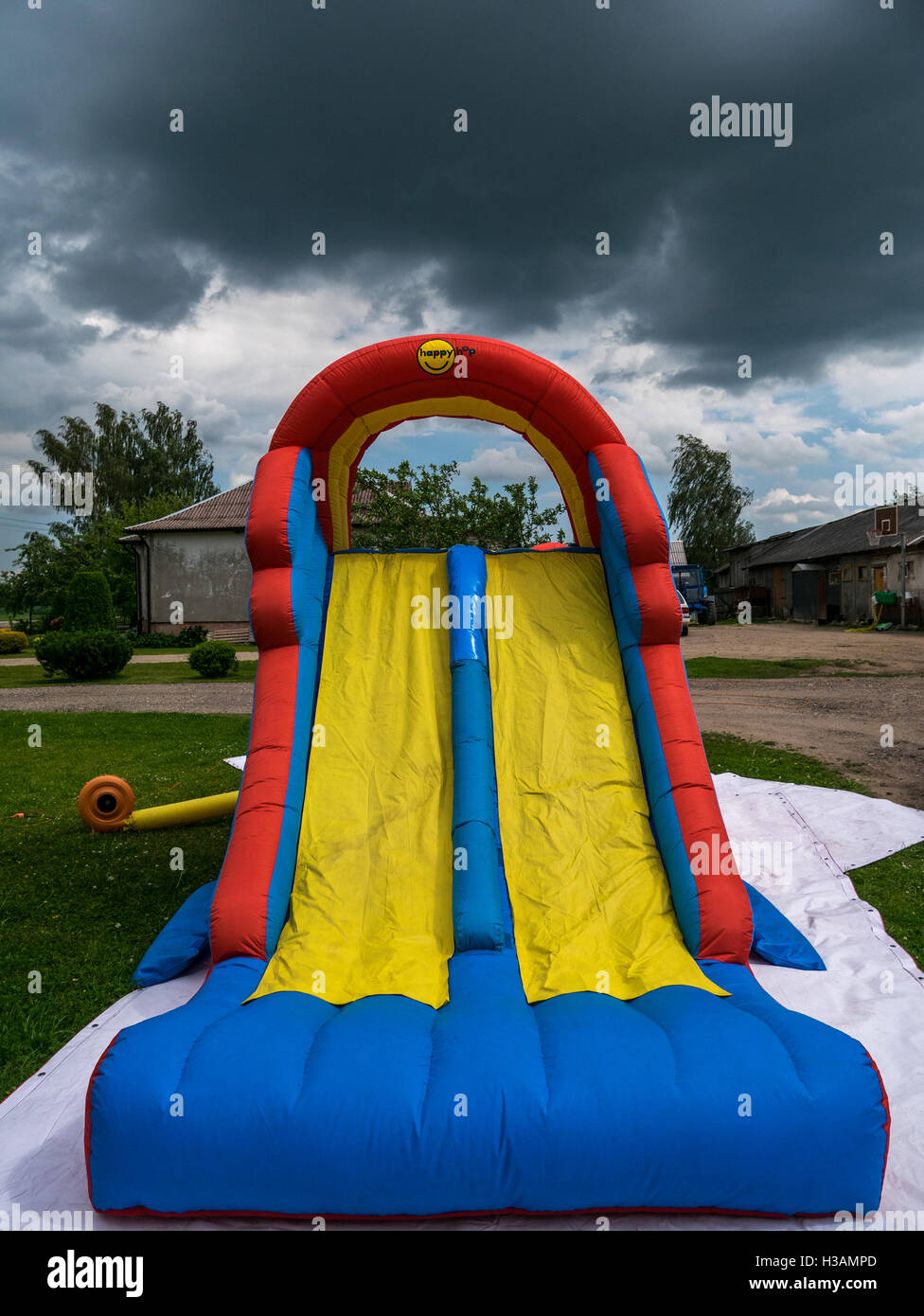 Inflatable kids trampoline of a bright colors standing in backyard ...