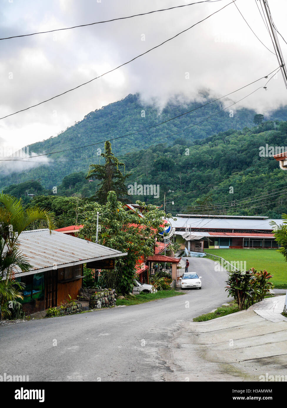 Turning Road in foothill of foggy volcano Stock Photo - Alamy