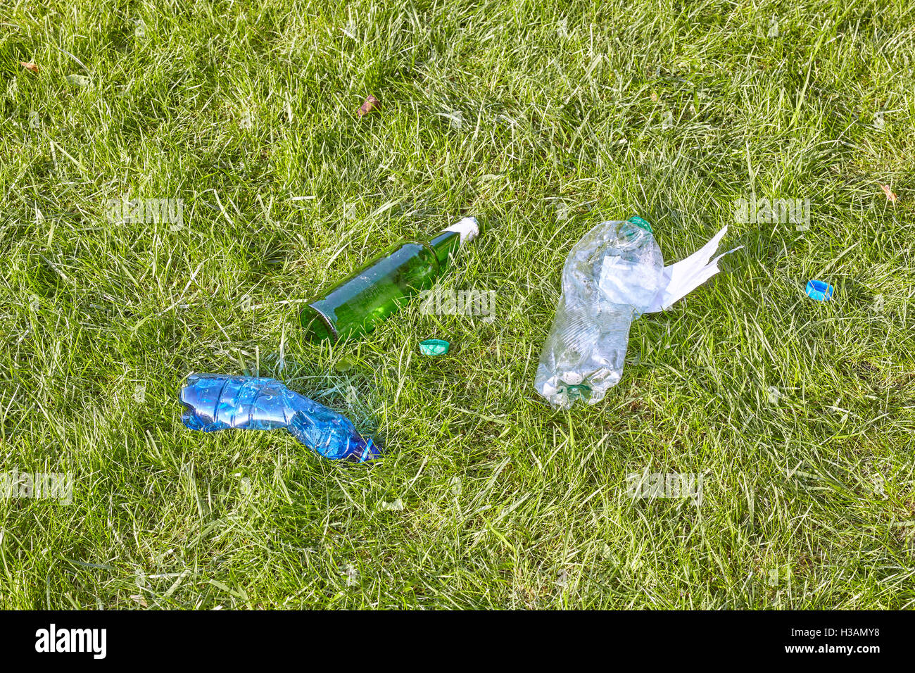 Lawn littered with bottles, environmental pollution concept picture ...