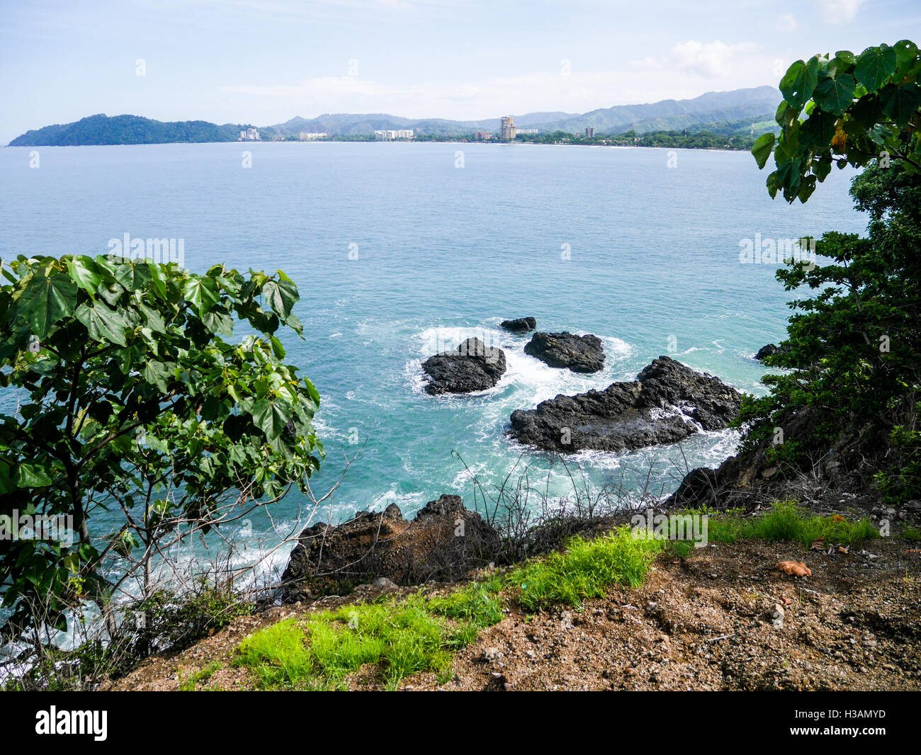 Blue ocean view in Costa Rica. Landscape with mountains and city far ...