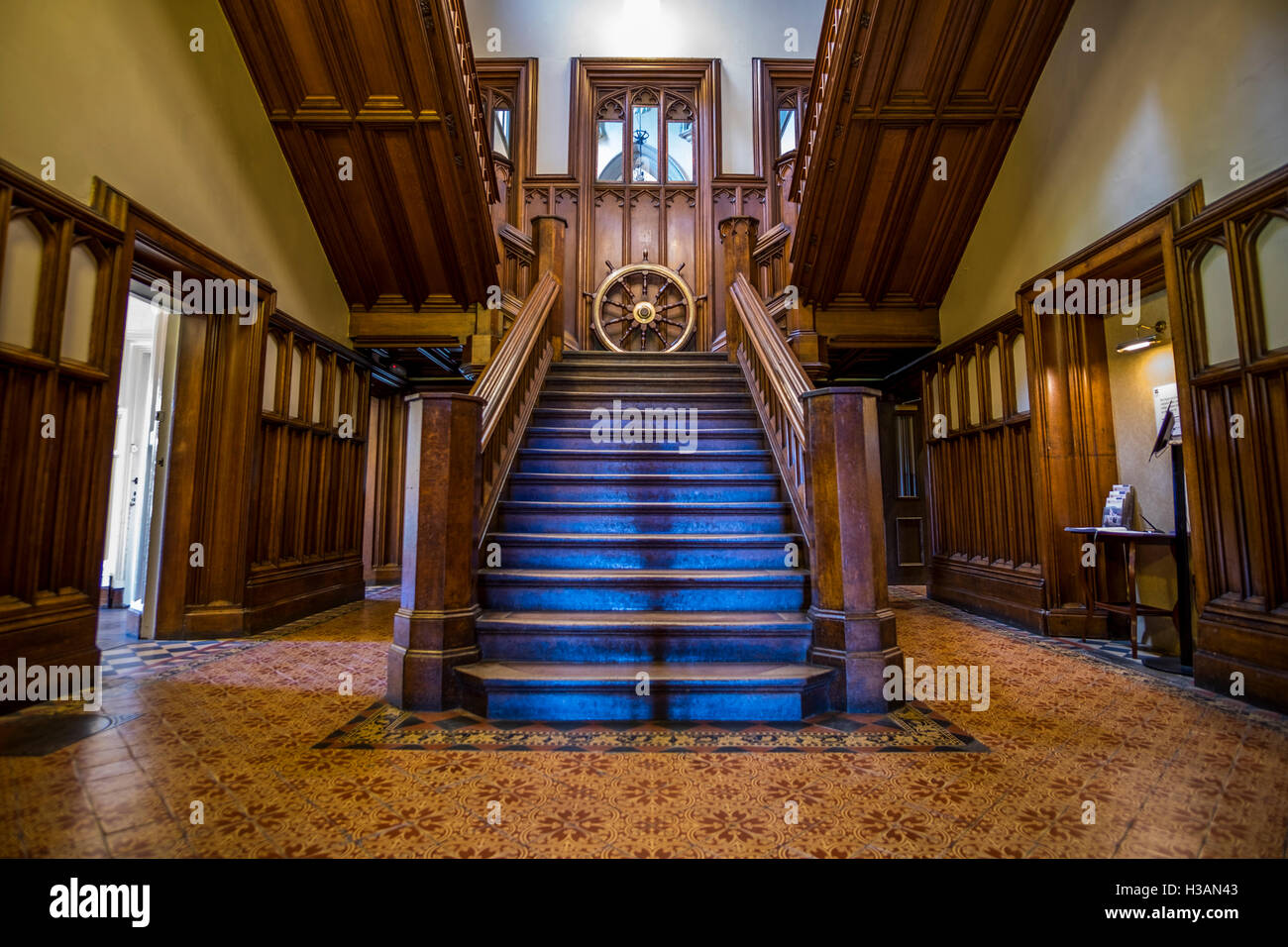 A wooden staircase leading up to the first floor of a country house ...