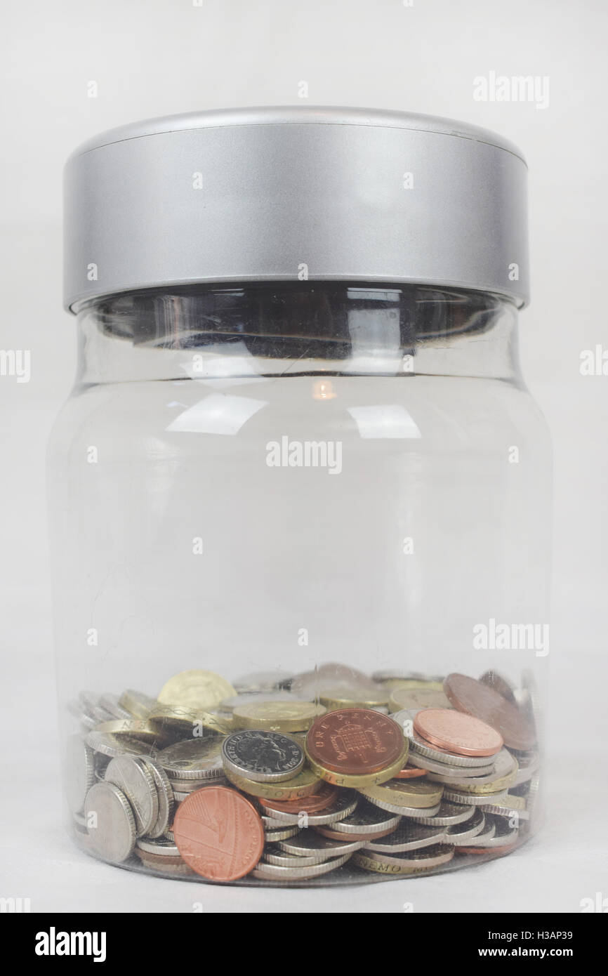 various mixed coinsa piggy bank savings pot Stock Photo - Alamy