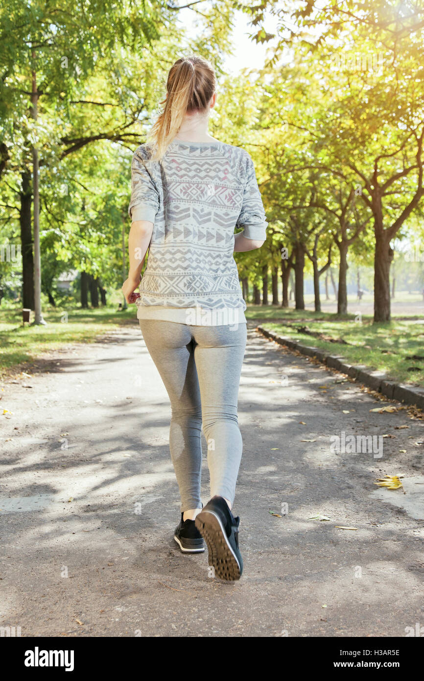 Back view of running woman in the park Stock Photo - Alamy