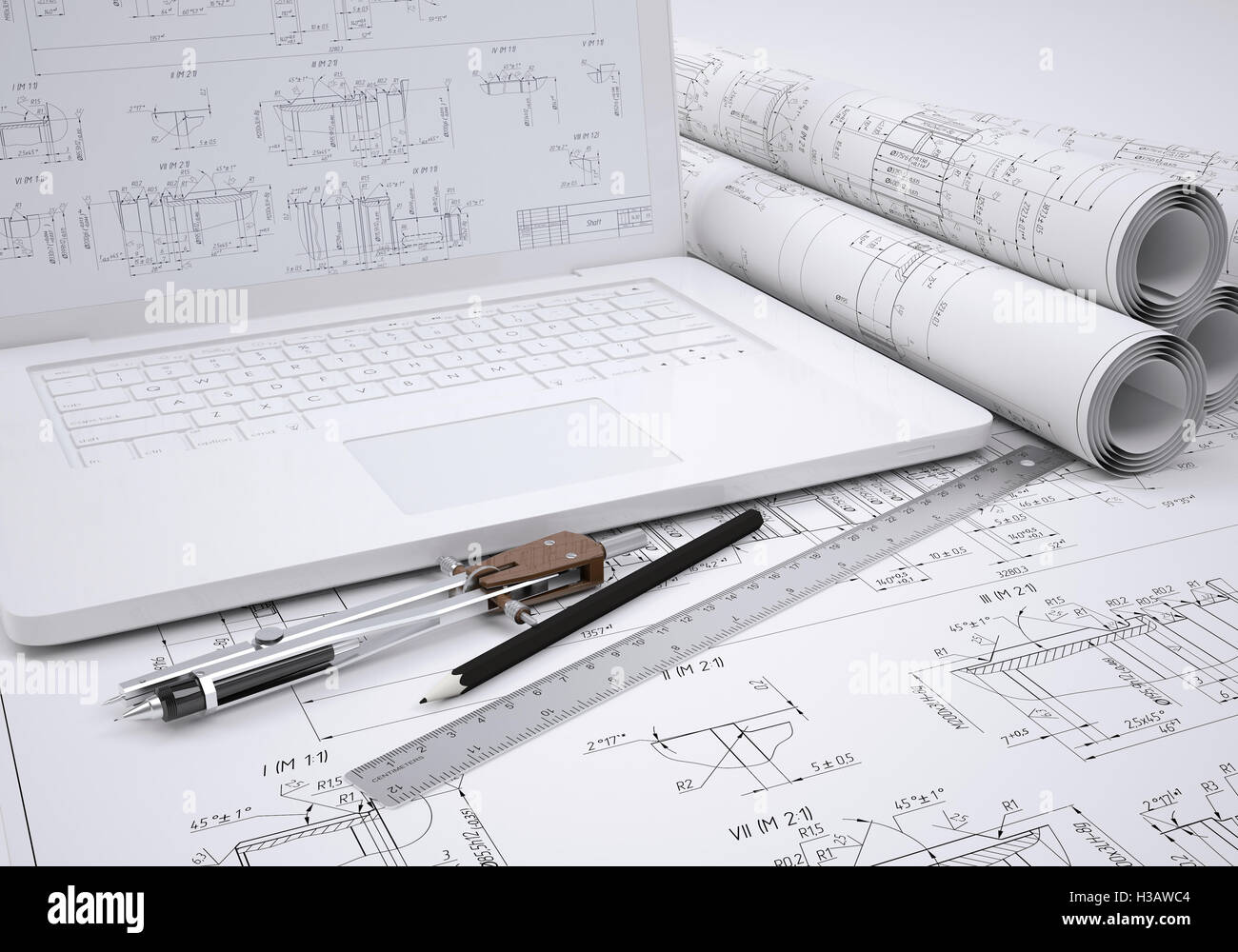 Scrolls engineering drawings and laptop Stock Photo - Alamy