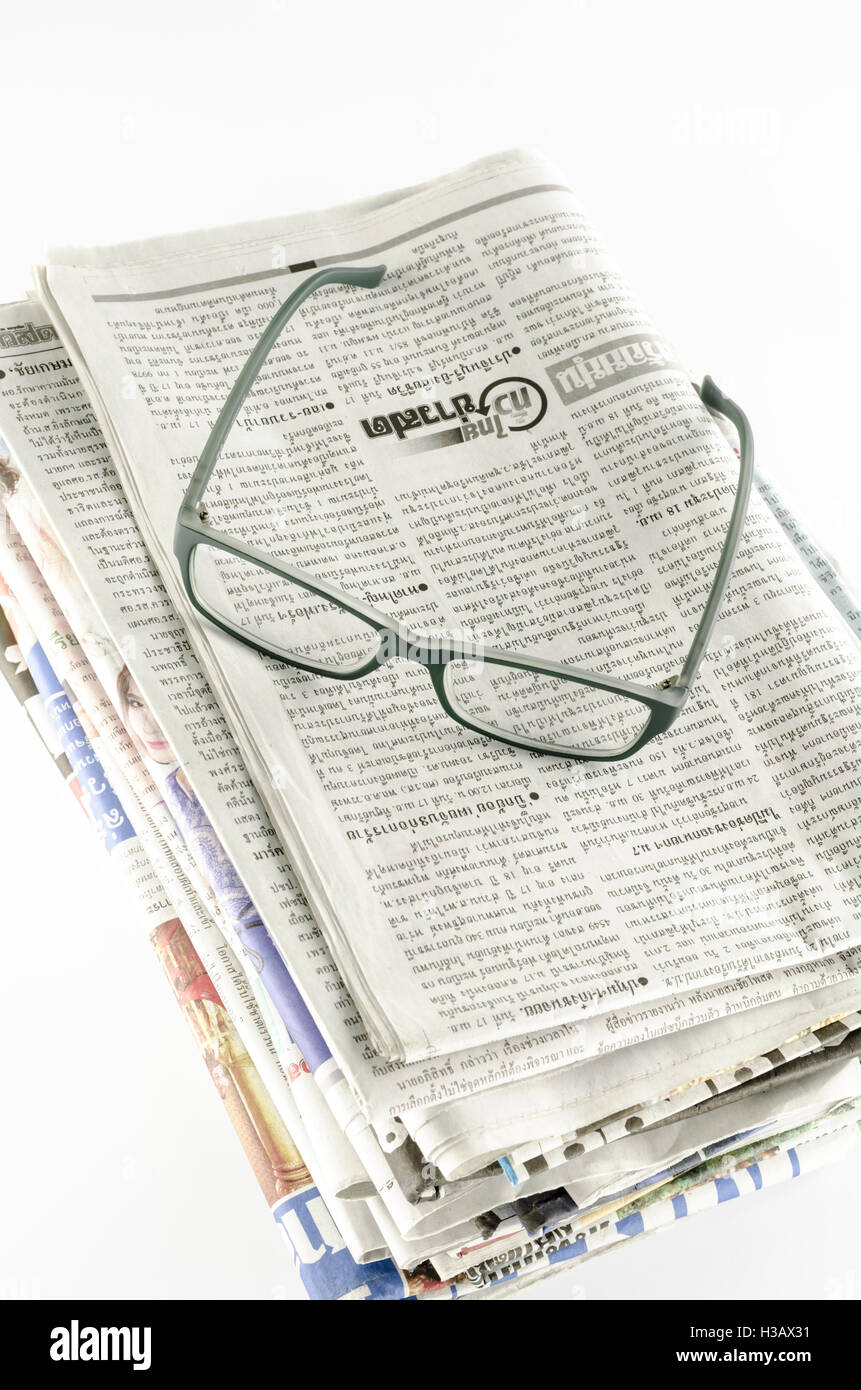 stack of newspaper with glasses Stock Photo - Alamy