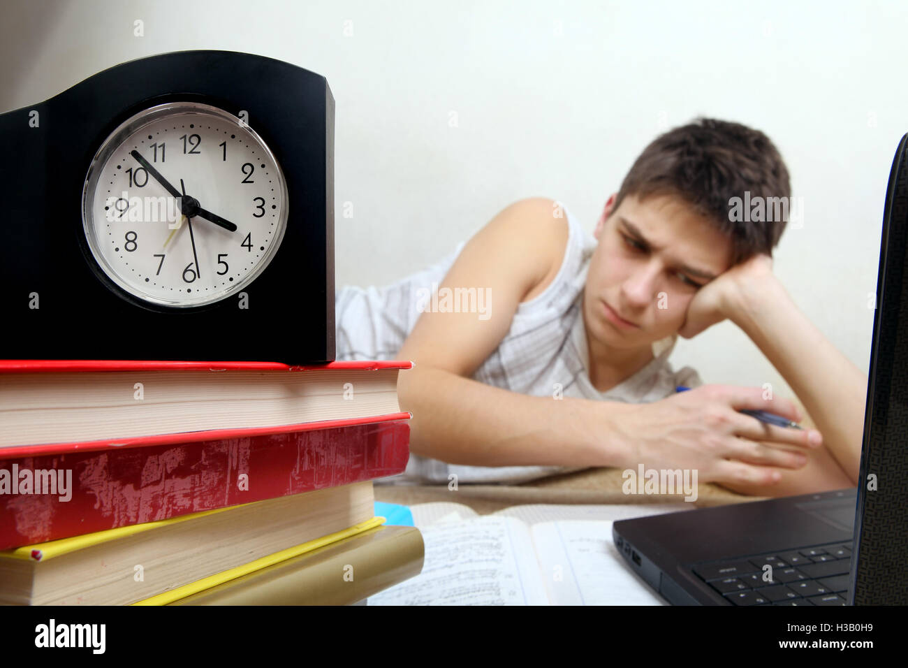 Tired Teenager doing Homework Stock Photo - Alamy