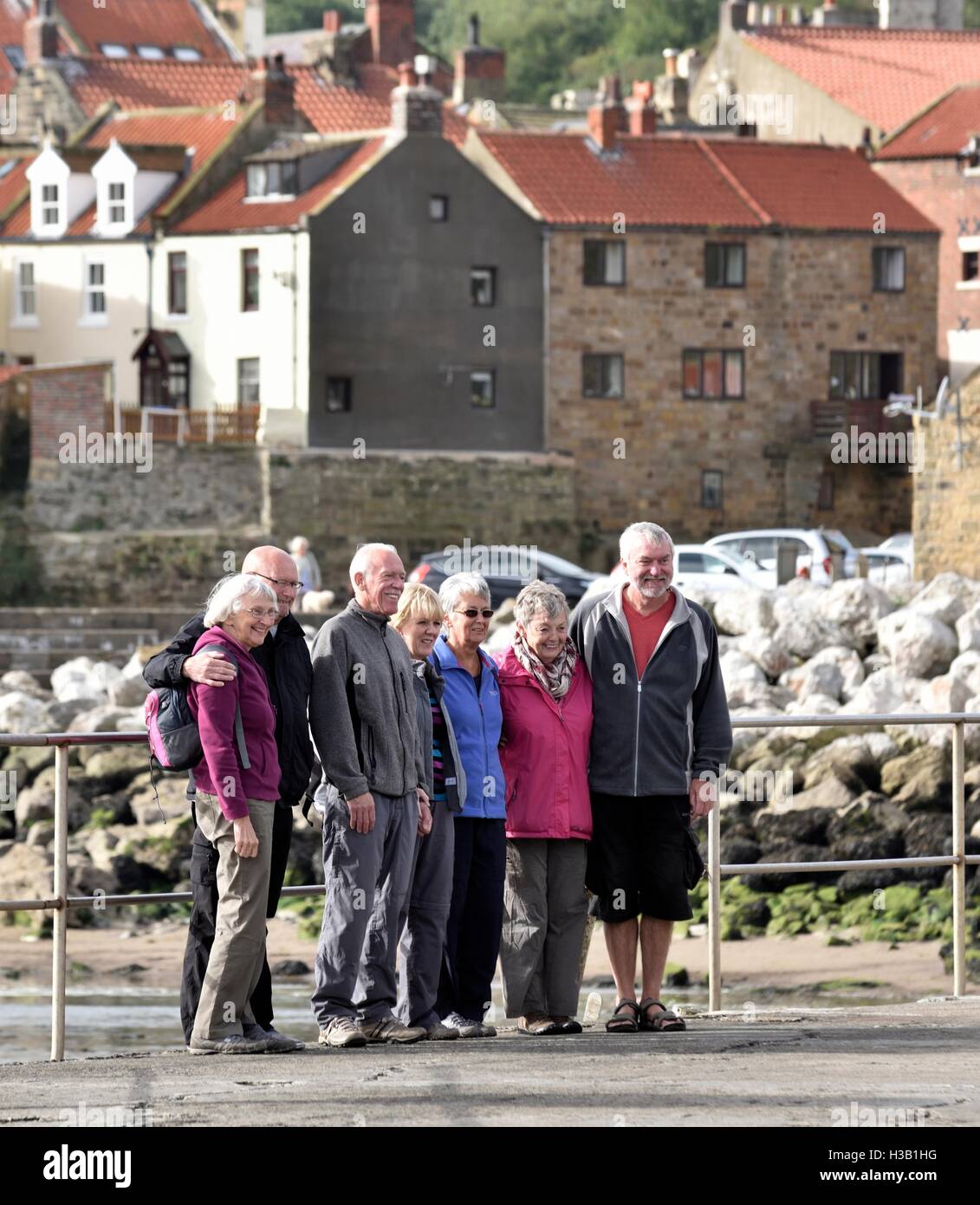 A group of friends posing for a photograph in Staithes North Yorkshire ...