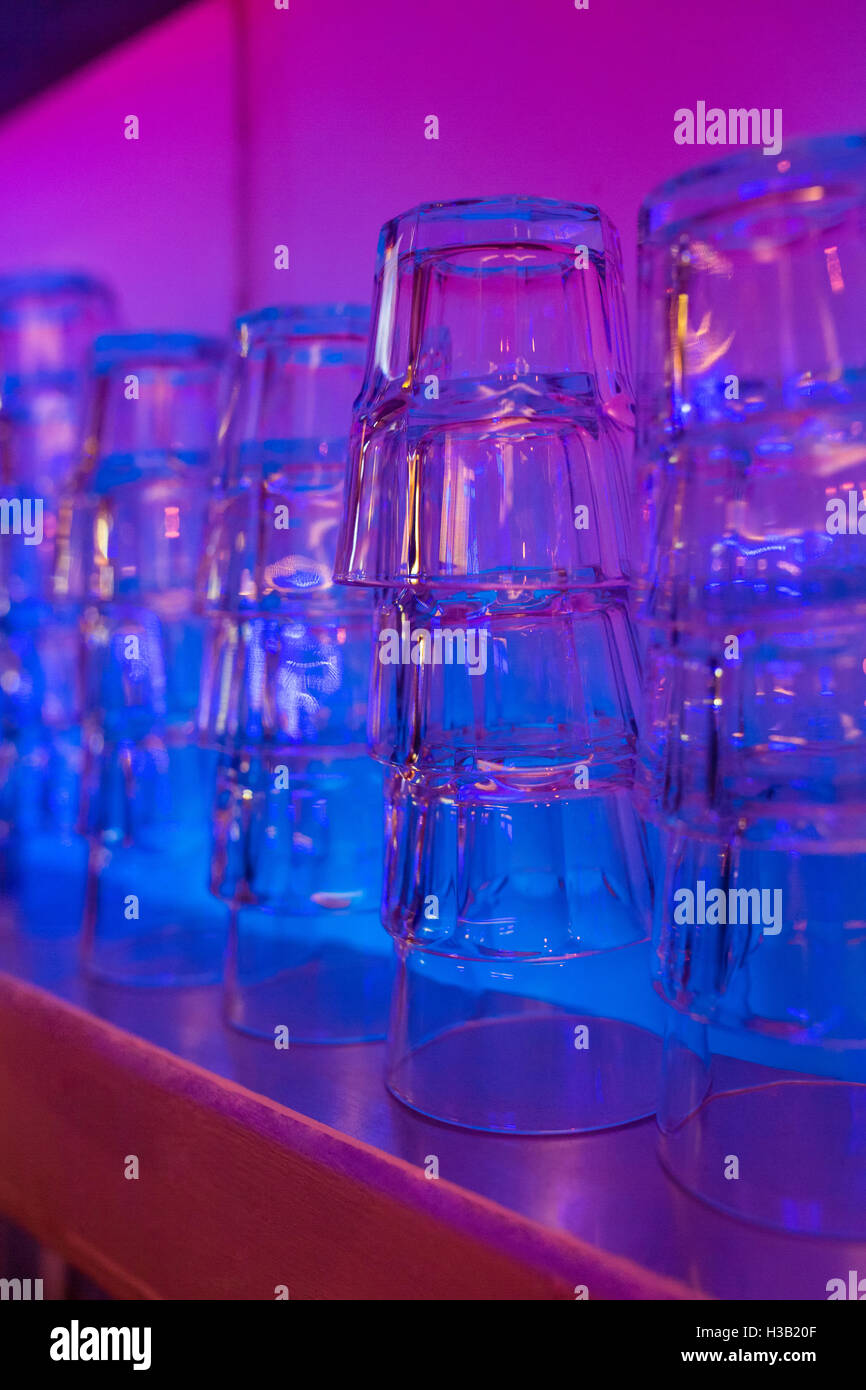 Glass stacked on bar counter Stock Photo - Alamy