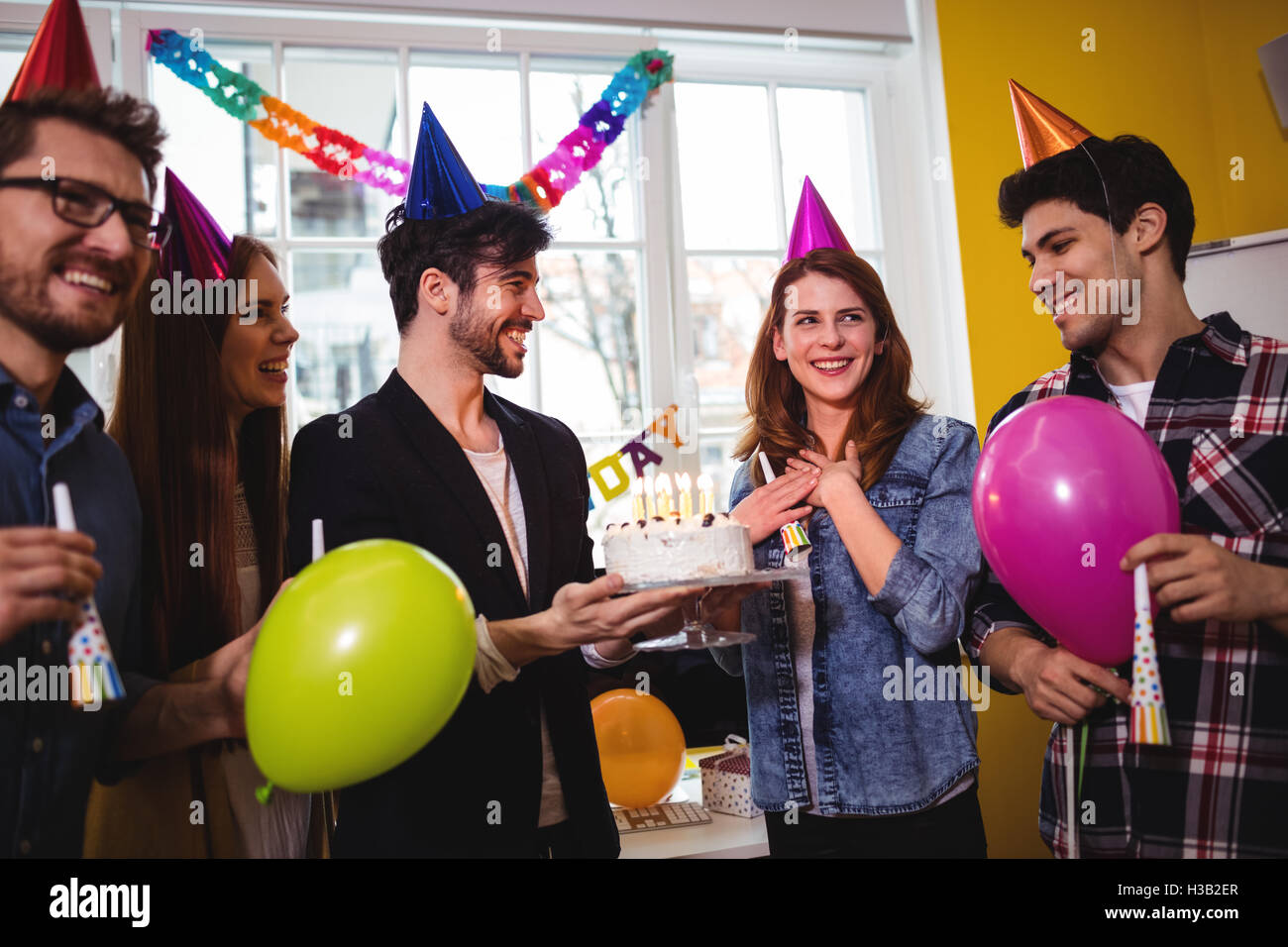 Happy coworkers celebrating businesswoman birthday Stock Photo - Alamy