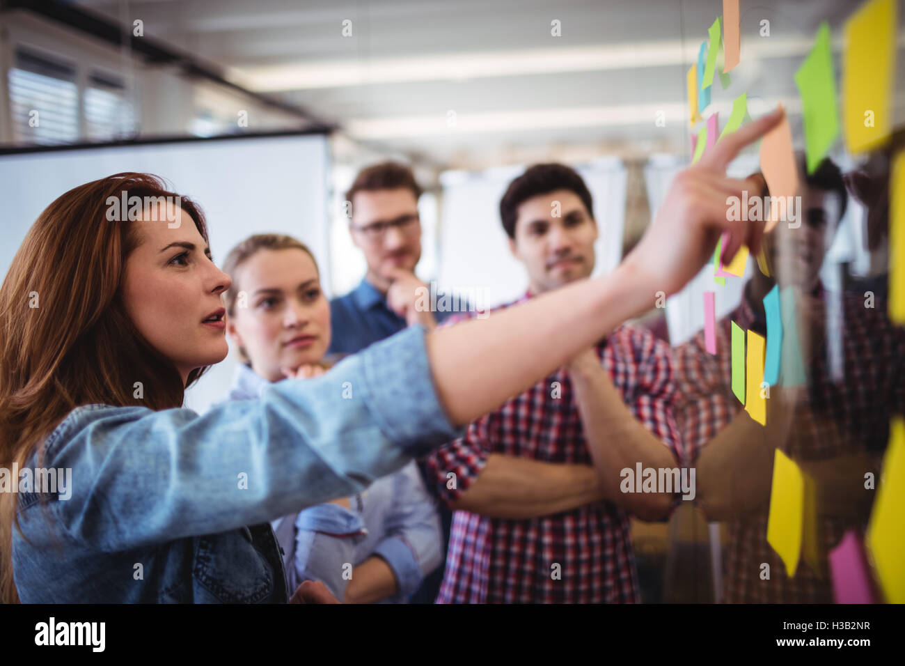Businesswoman pointing at sticky notes Stock Photo - Alamy