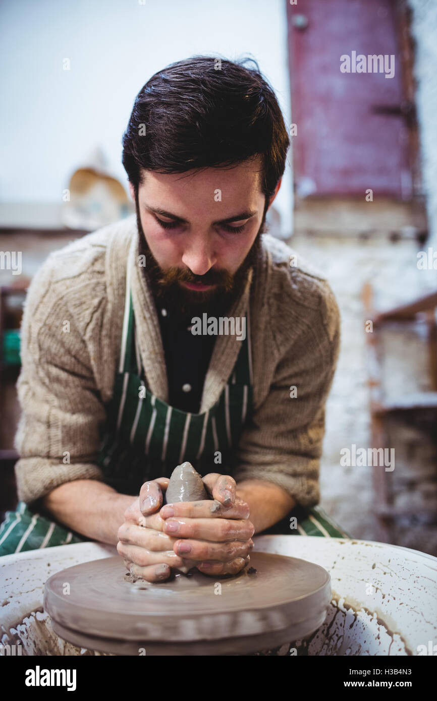 Hipster molding shape in pottery workshop Stock Photo - Alamy