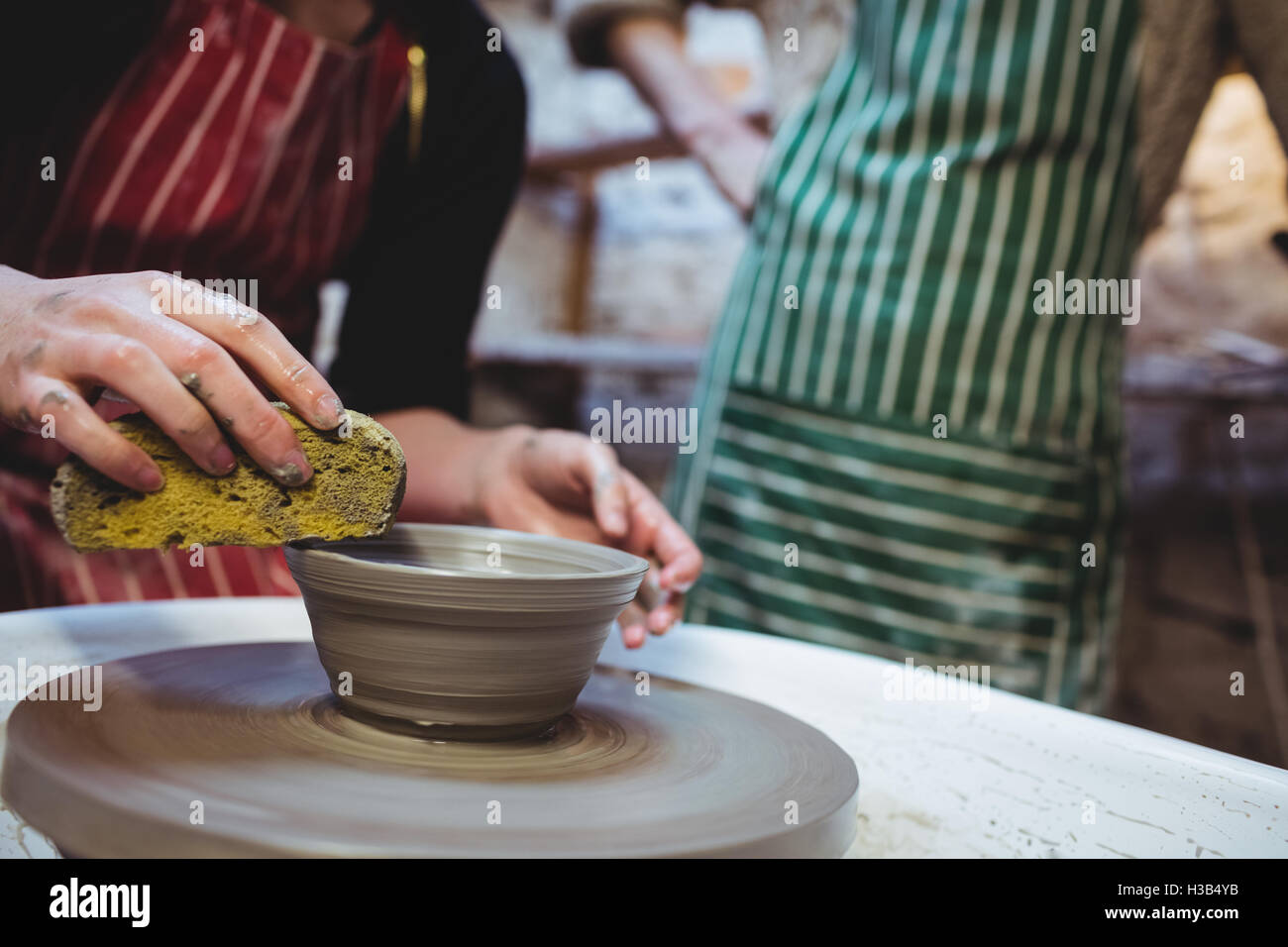 Craftsmen working in pottery workshop Stock Photo - Alamy
