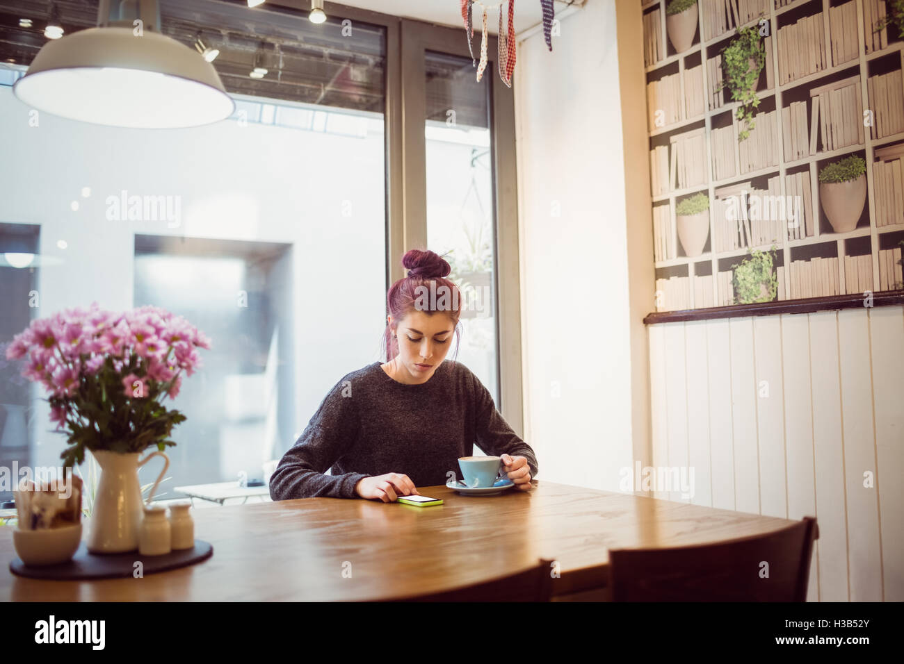 Hipster drinking a cup of coffee Stock Photo - Alamy