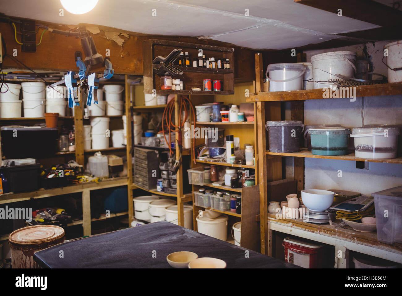Containers on shelves at workshop Stock Photo - Alamy