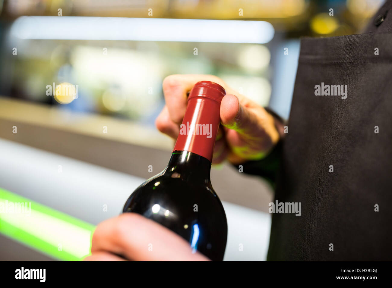 Waiter holding wine hi-res stock photography and images - Alamy