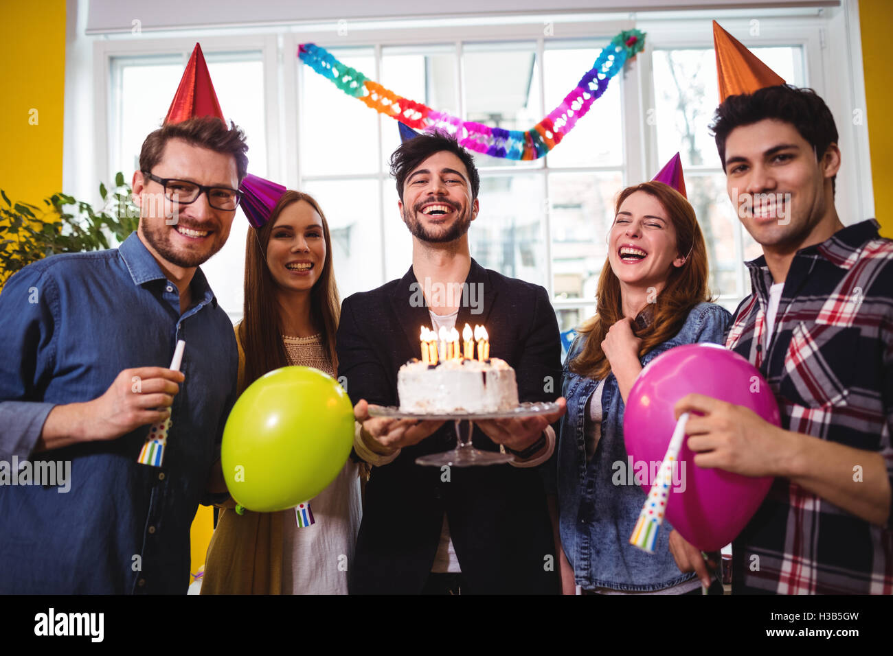 Business people laughing while celebrating birthday Stock Photo - Alamy