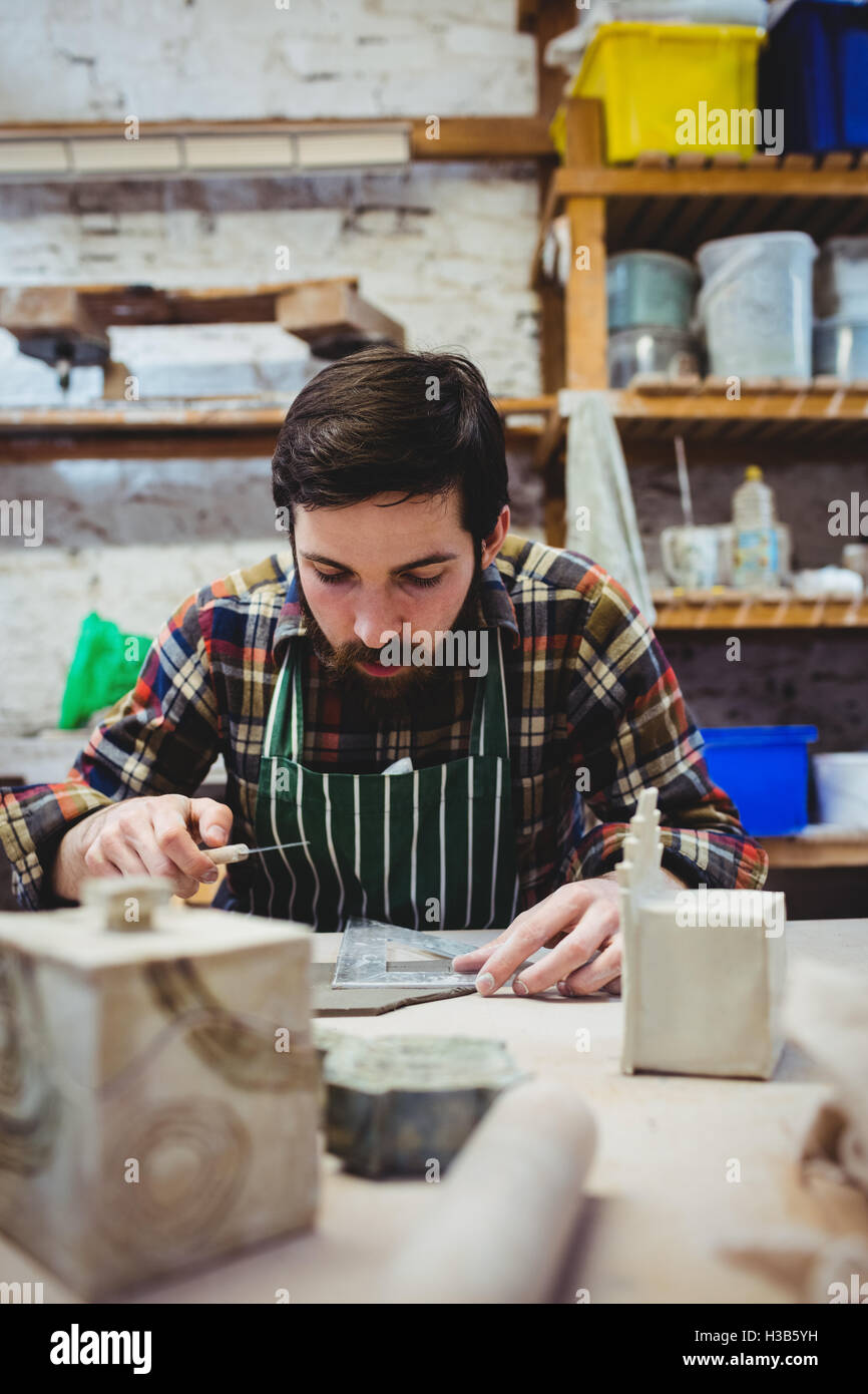 Concentrated man working at workshop Stock Photo - Alamy