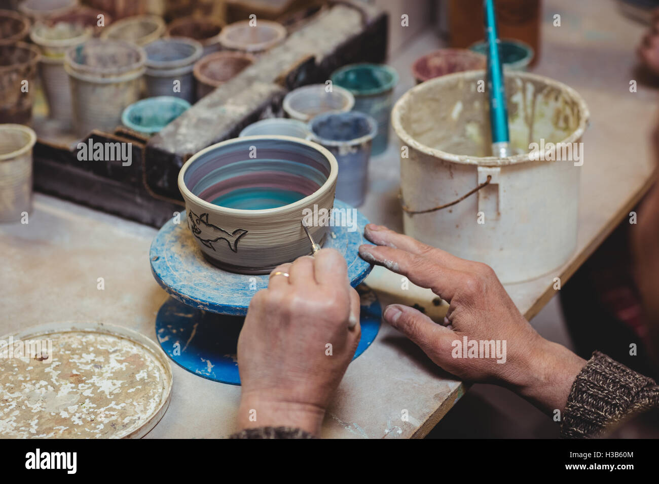 Cropped image of potter working Stock Photo - Alamy