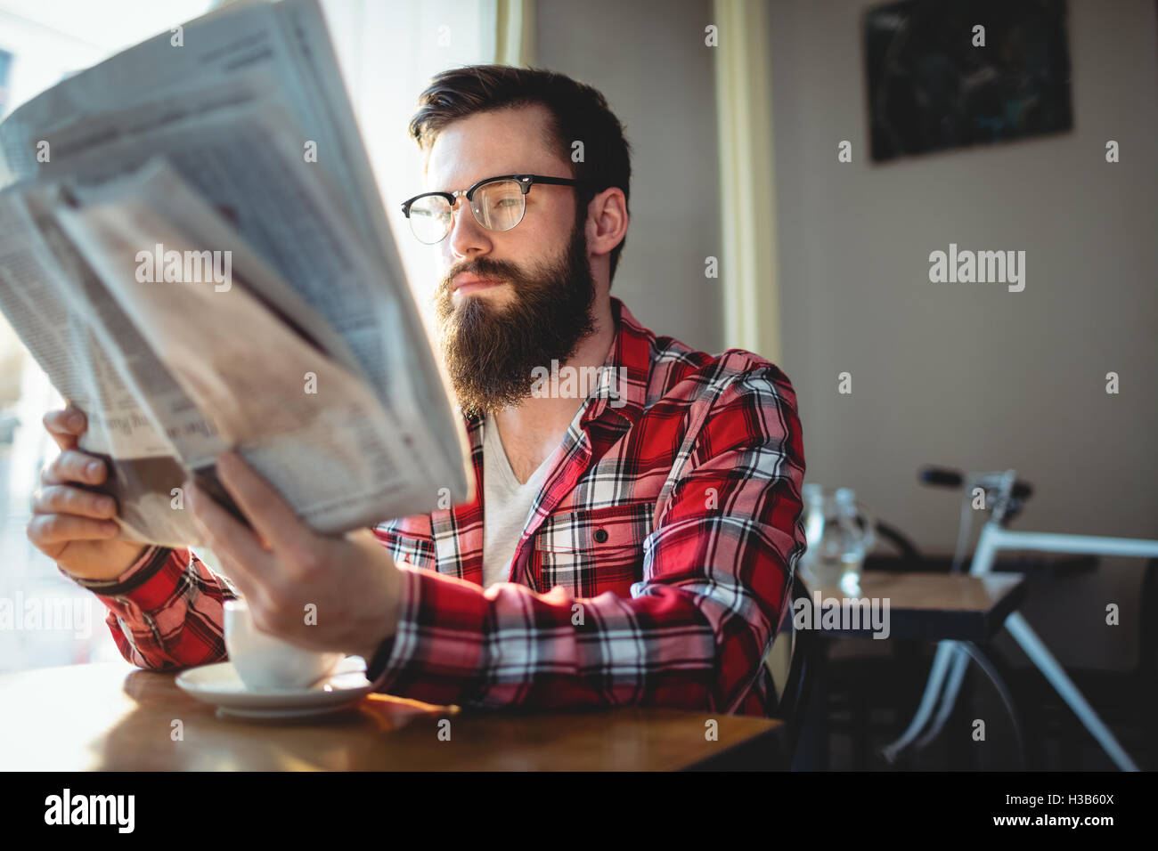 Customer reading newspaper at coffee house Stock Photo - Alamy