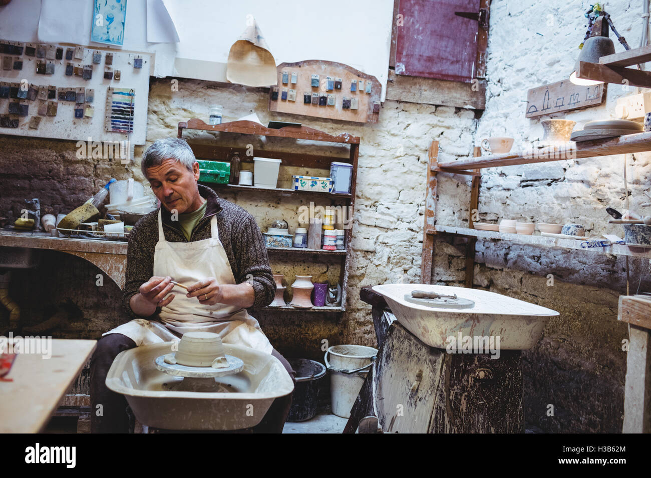 Male craftsperson at pottery workshop Stock Photo - Alamy