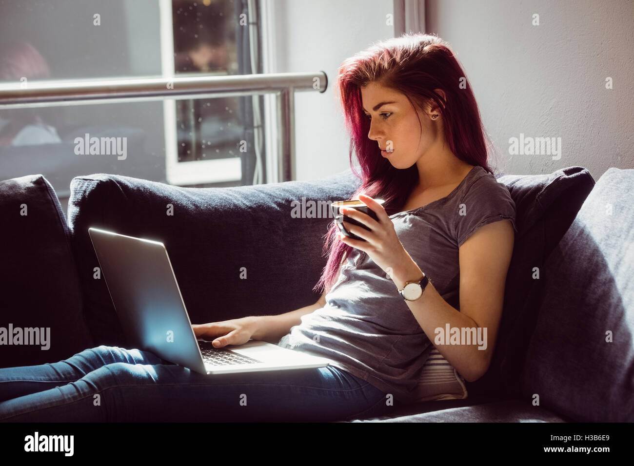 beautiful woman using computer with a coffee Stock Photo - Alamy