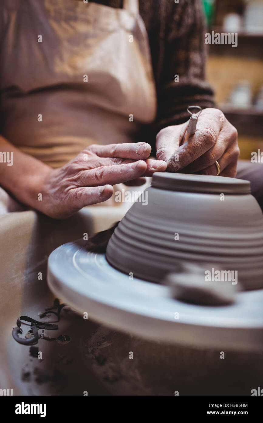 Midsection of craftsman making ceramic container Stock Photo - Alamy