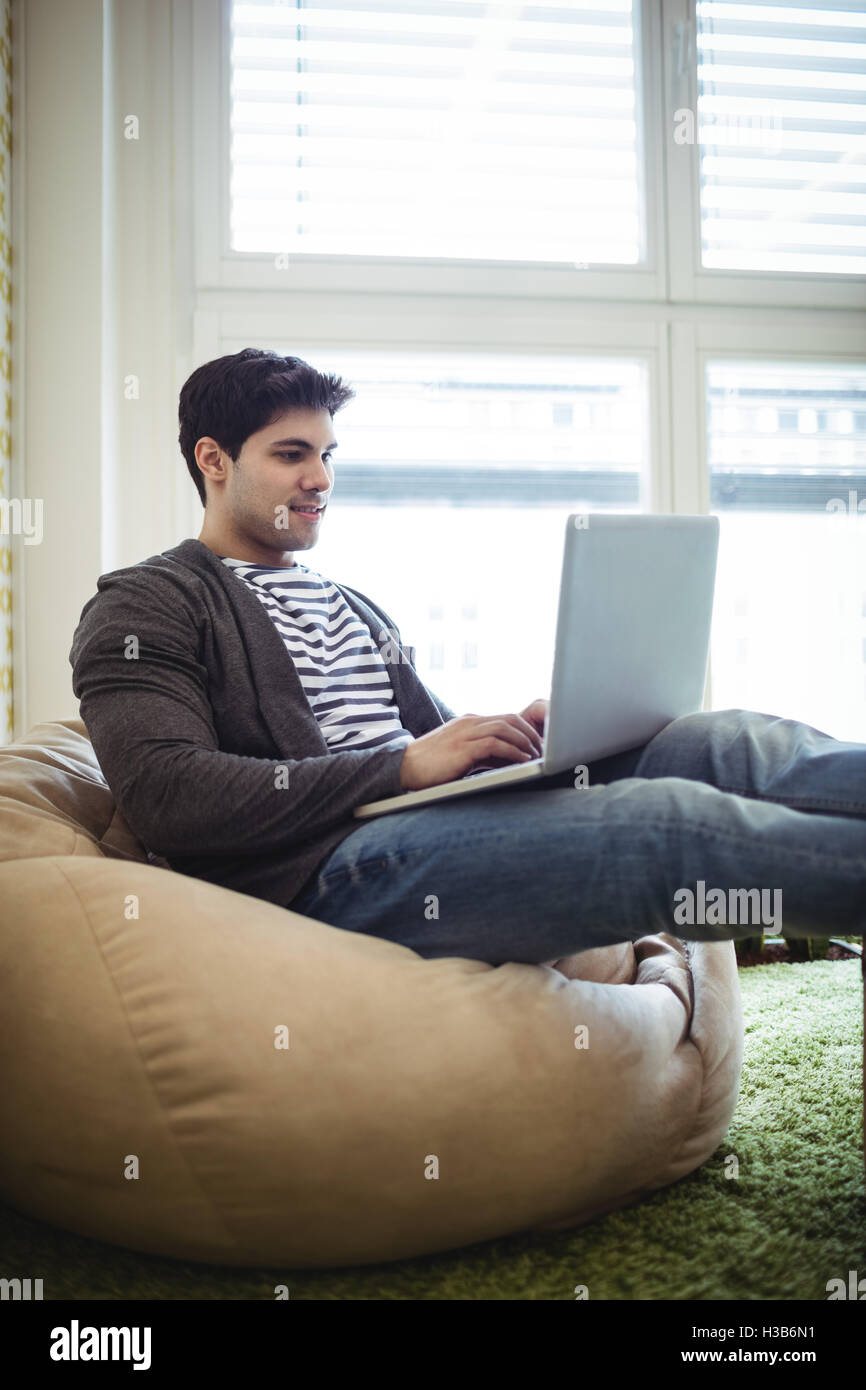 Relaxed photo editor using laptop Stock Photo - Alamy