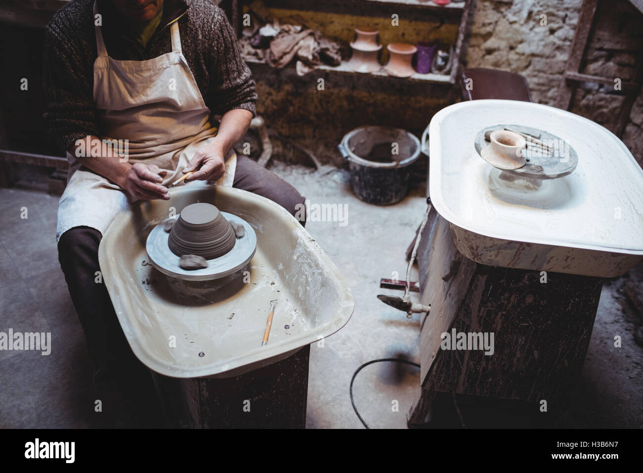 Craftsman making ceramic container Stock Photo - Alamy