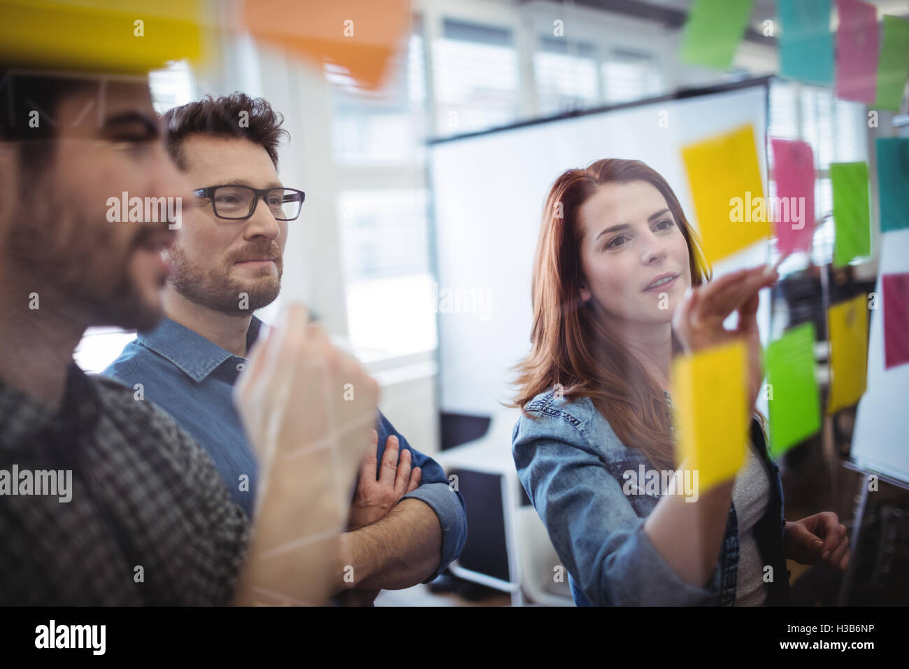 Creative business people writing on sticky notes Stock Photo - Alamy
