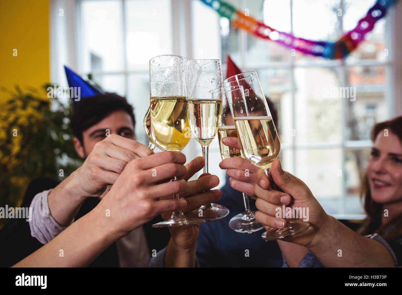Cropped image of business people toasting drink Stock Photo - Alamy