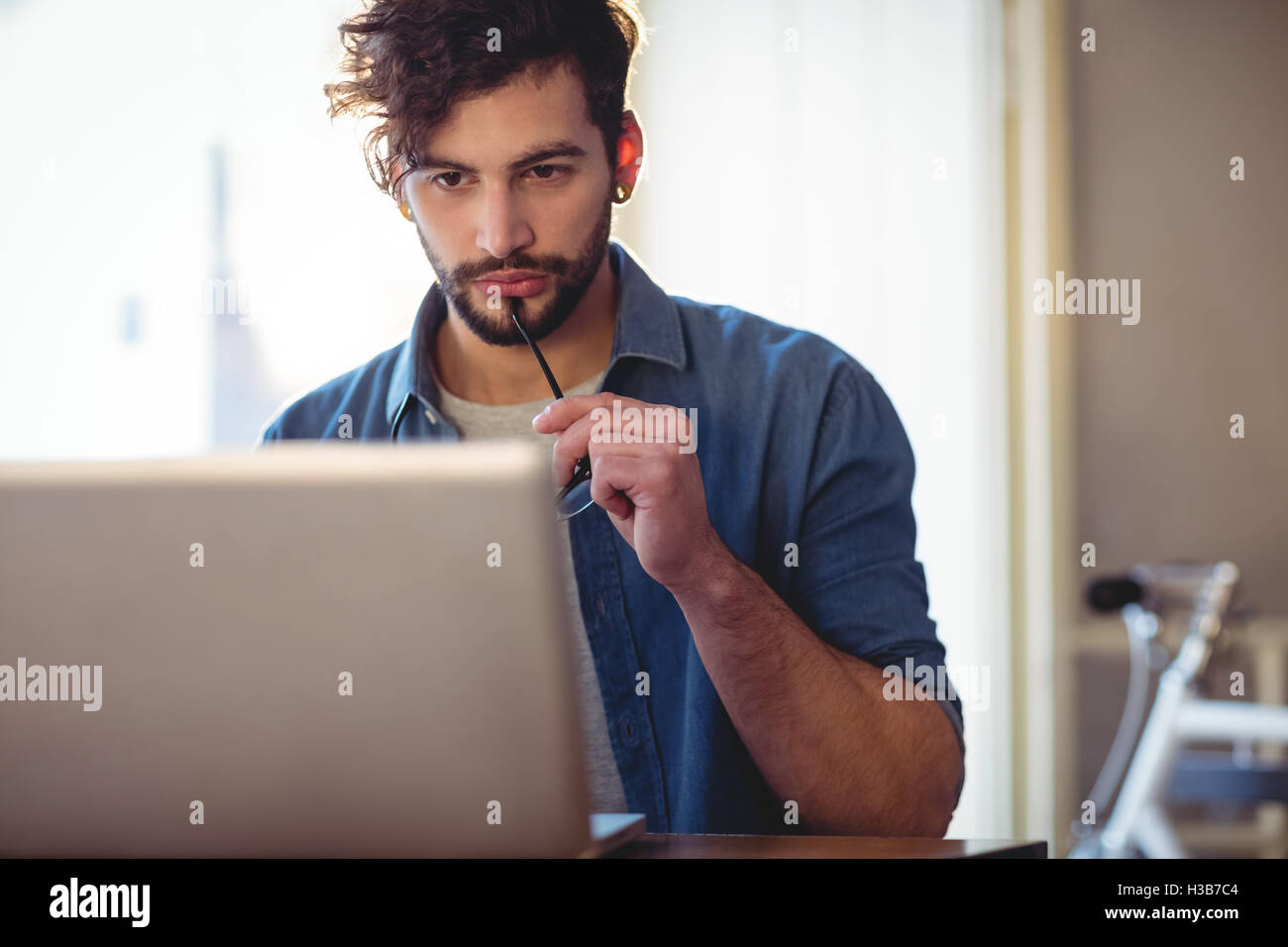 Handsome male customer using laptop at cafeteria Stock Photo - Alamy